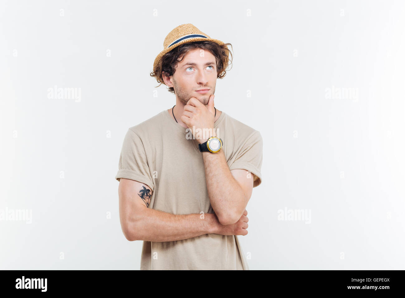 Thoughtful handsome young man standing and thinking over white ...