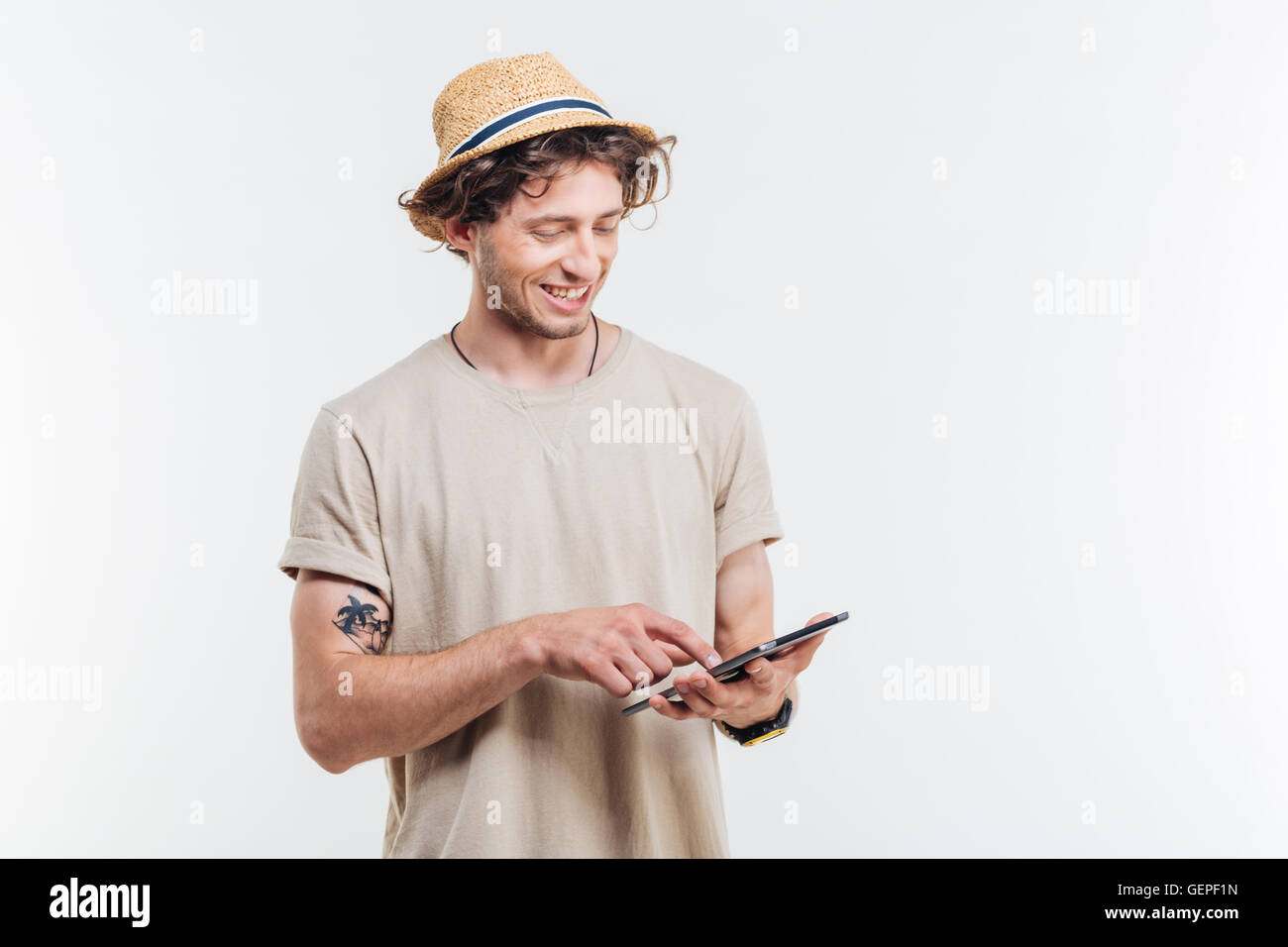 Happy handsome young man using tablet over white background Stock Photo ...