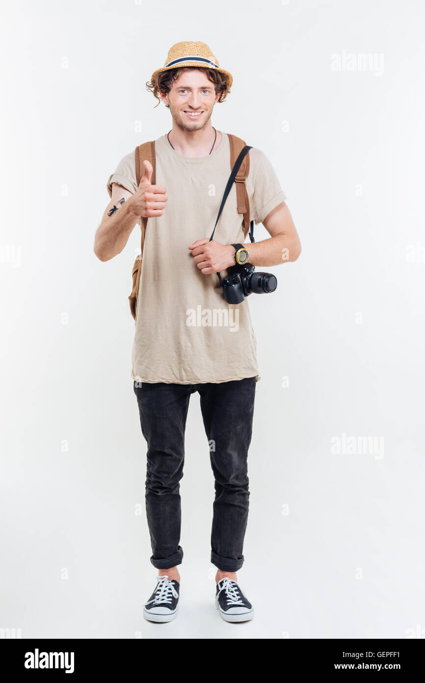 Full length portrait of handsome male tourist looking at camera and ...