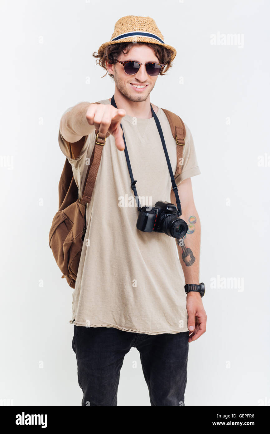 Young smiling man pointing finger at camera over white background Stock ...