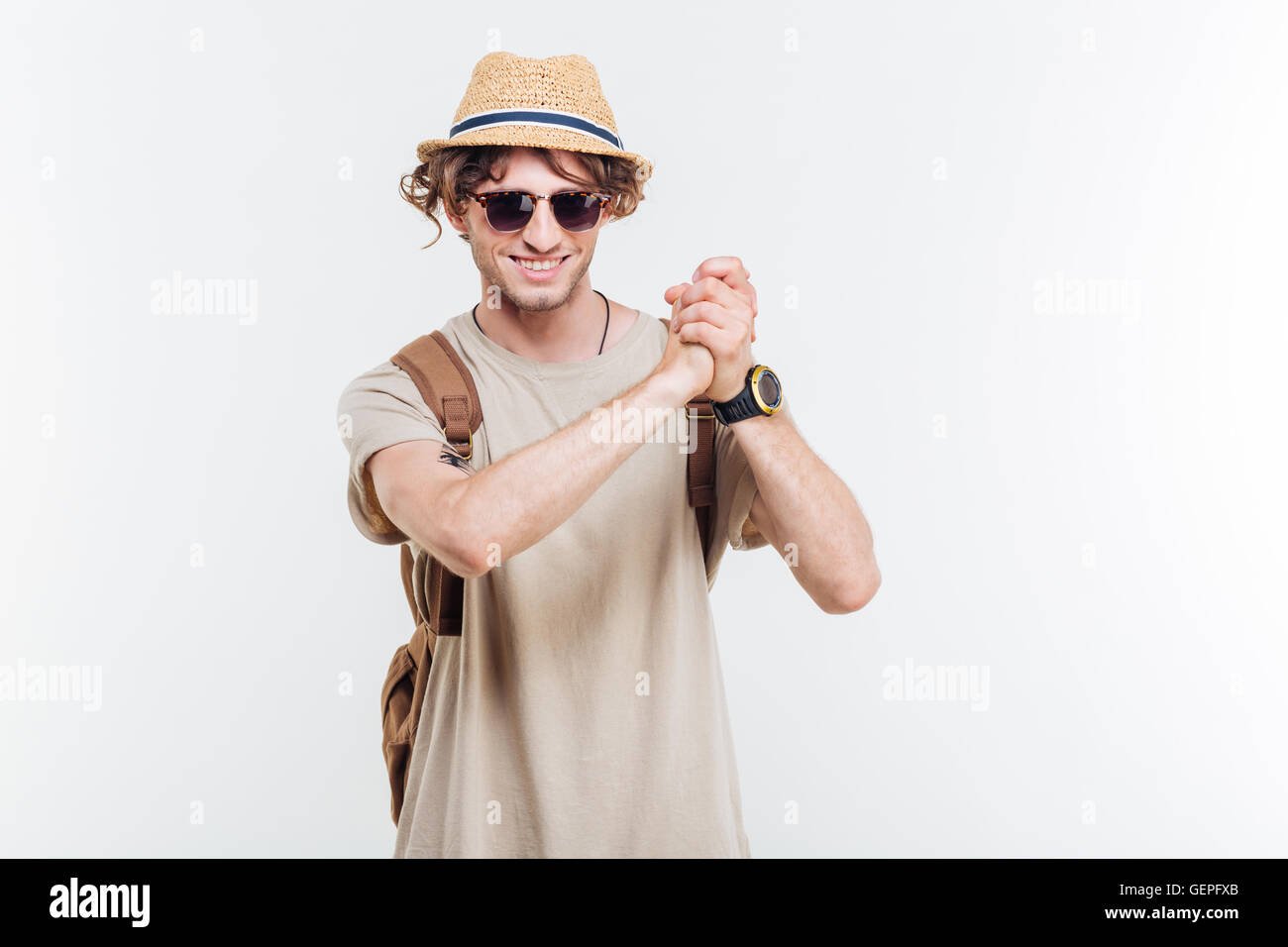 Young smiling stylish man showing well done gesture over white ...