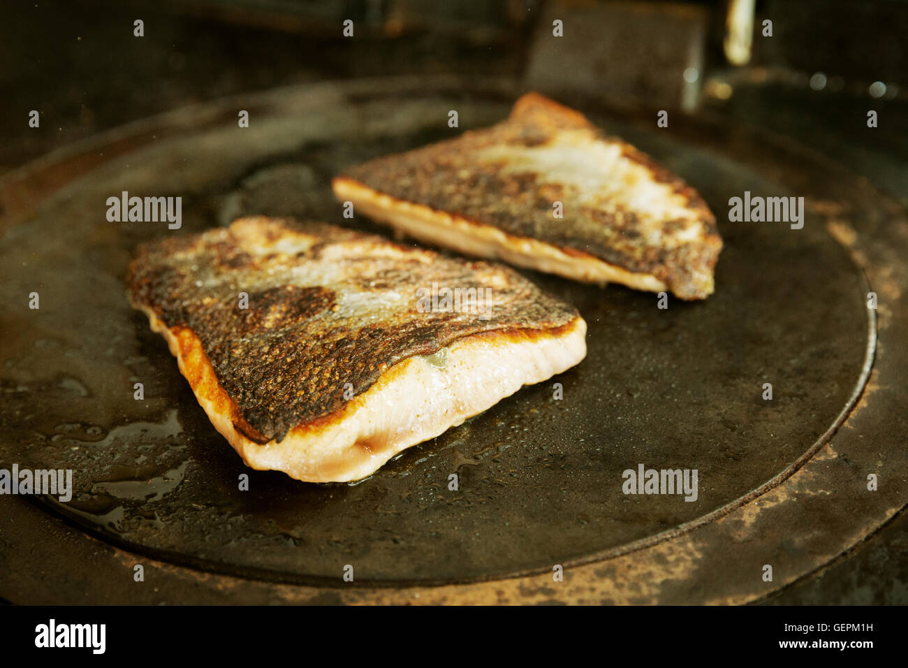 Close up of a pan-fried fillet of fish with crispy skin Stock Photo - Alamy