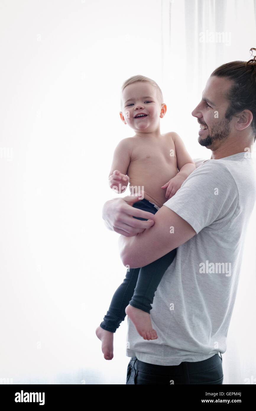 Father carrying child in arms hi-res stock photography and images - Alamy