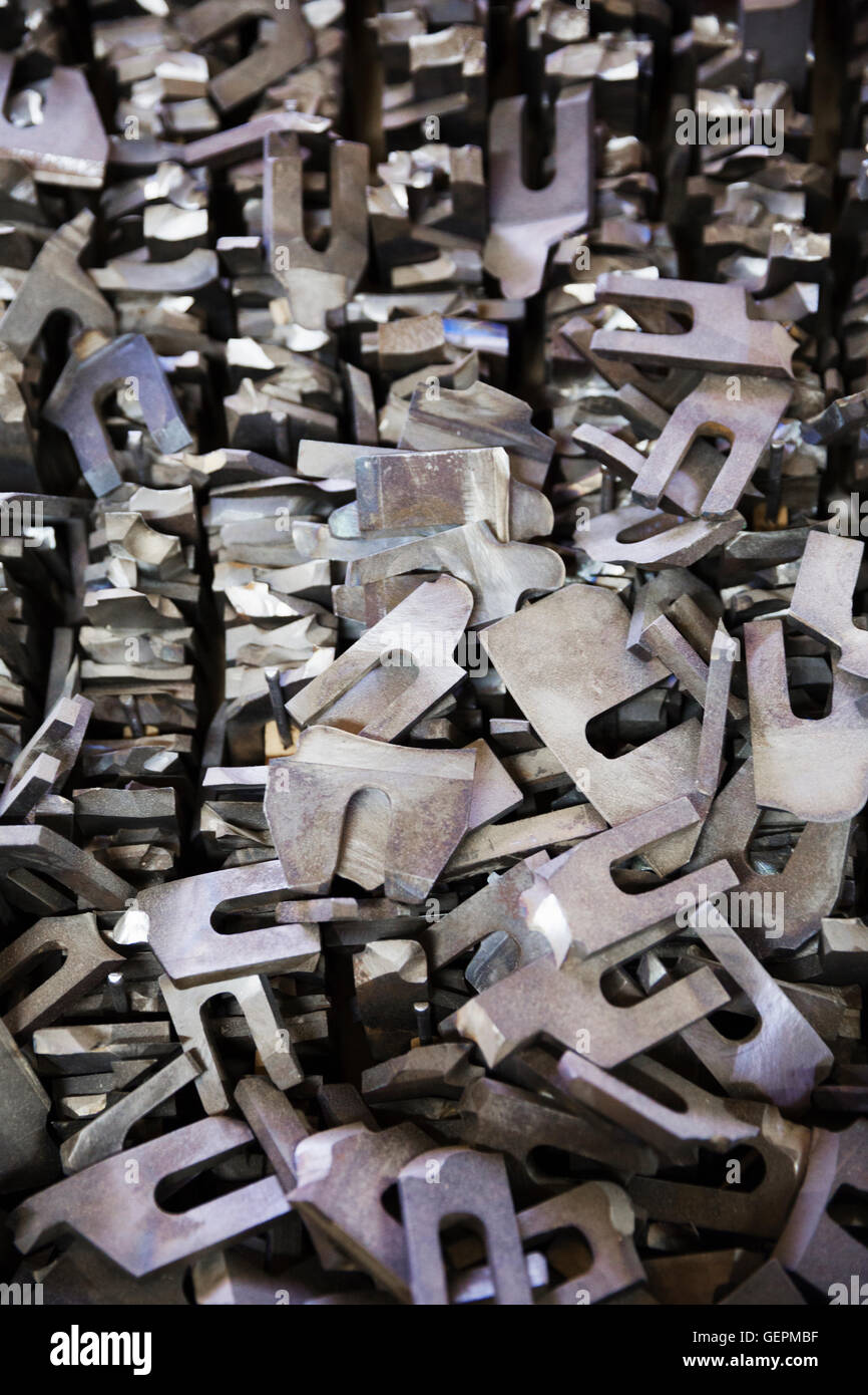 A pile of metal brackets and stacks of wood in a carpentry workshop ...