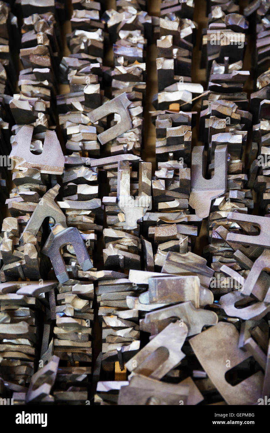 A pile of metal brackets and stacks of wood in a carpentry workshop ...