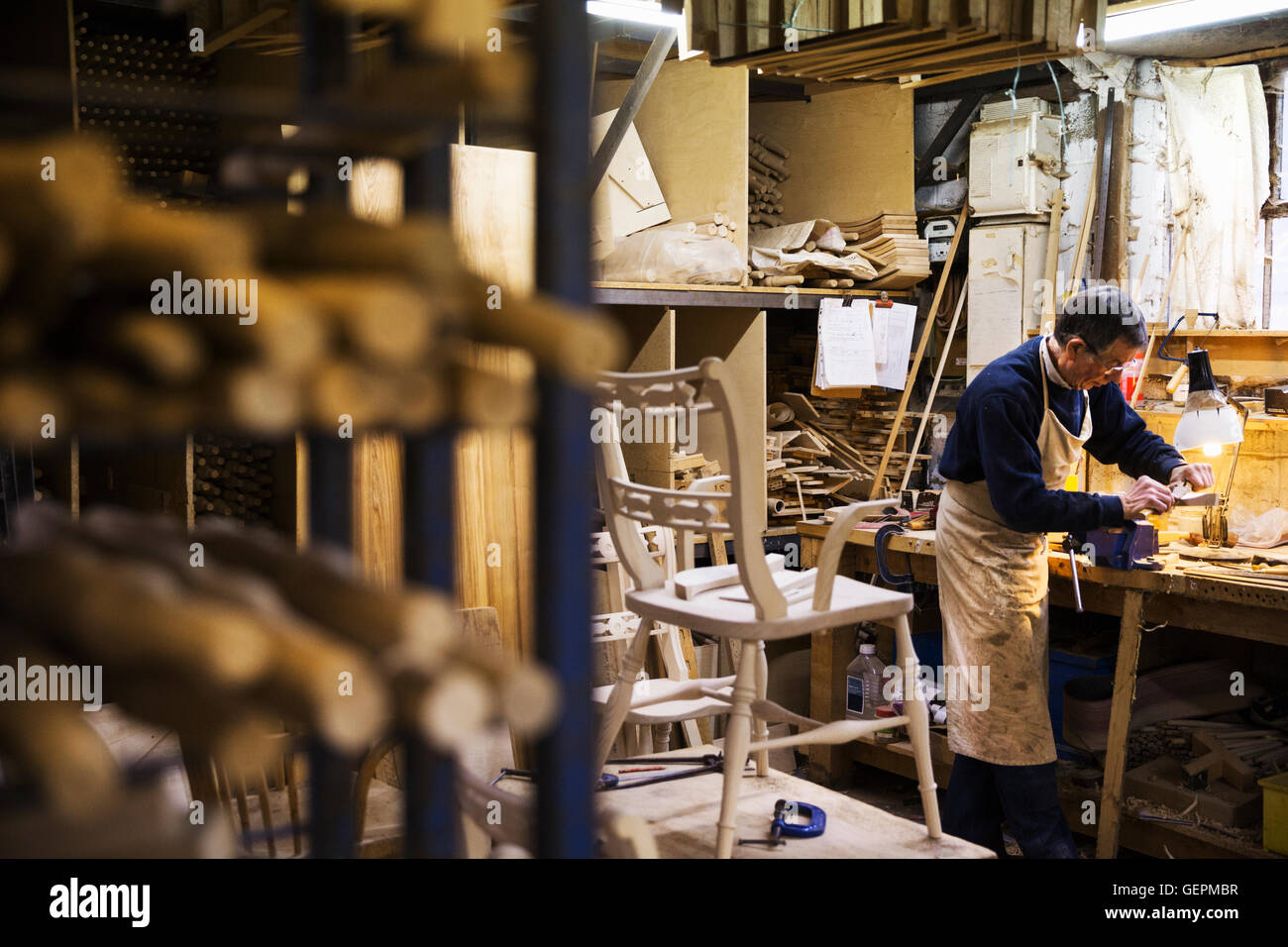 Man standing at a work bench in a carpentry workshop, working on a ...