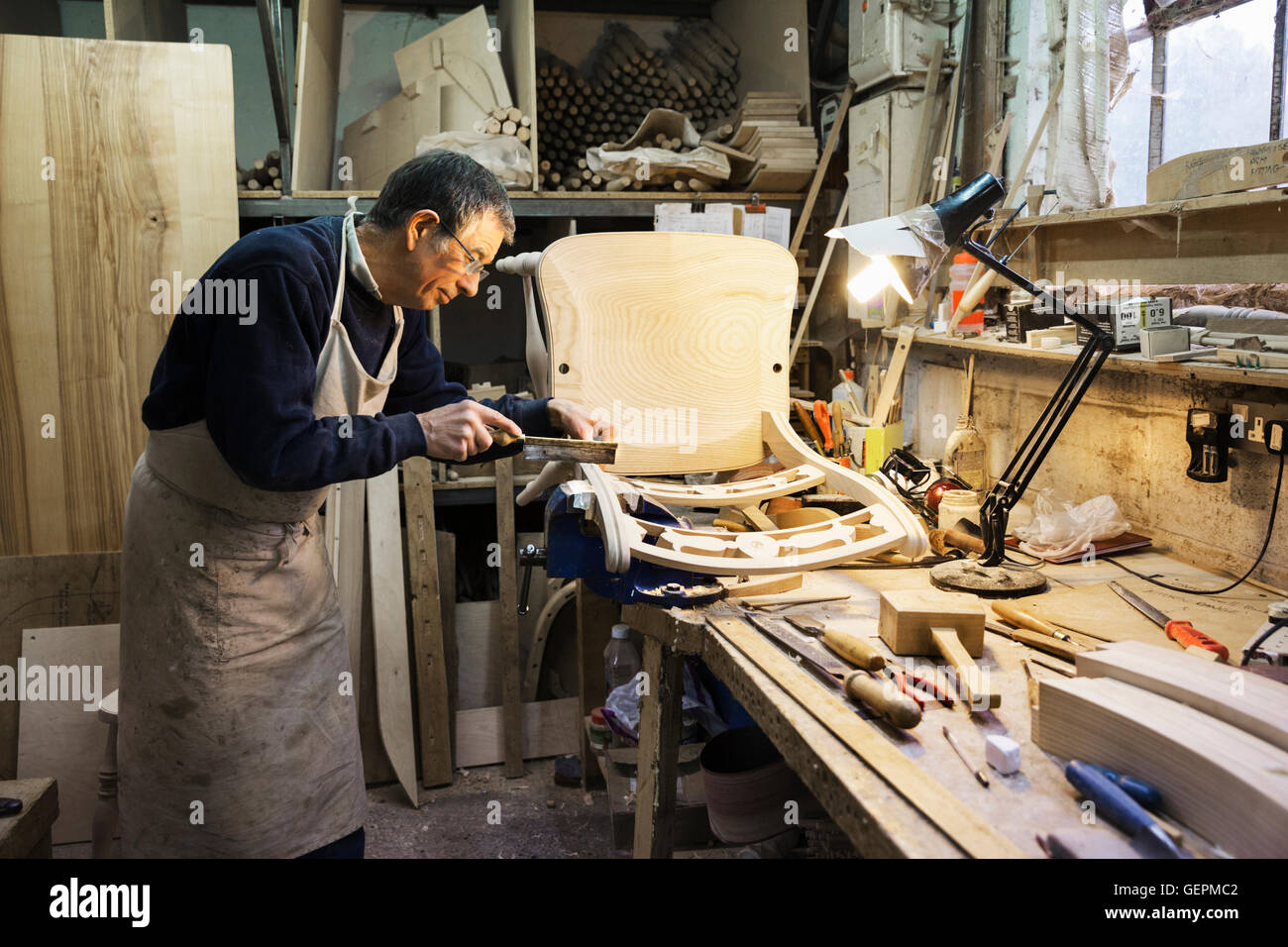 Man standing at a work bench in a carpentry workshop, working on a ...