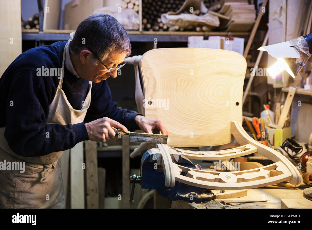 Man standing at a work bench in a carpentry workshop, working on a ...