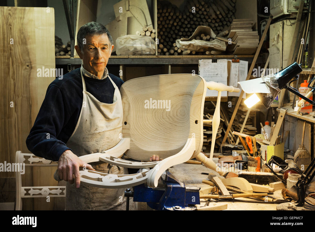 Man standing at a work bench in a carpentry workshop, working on a ...