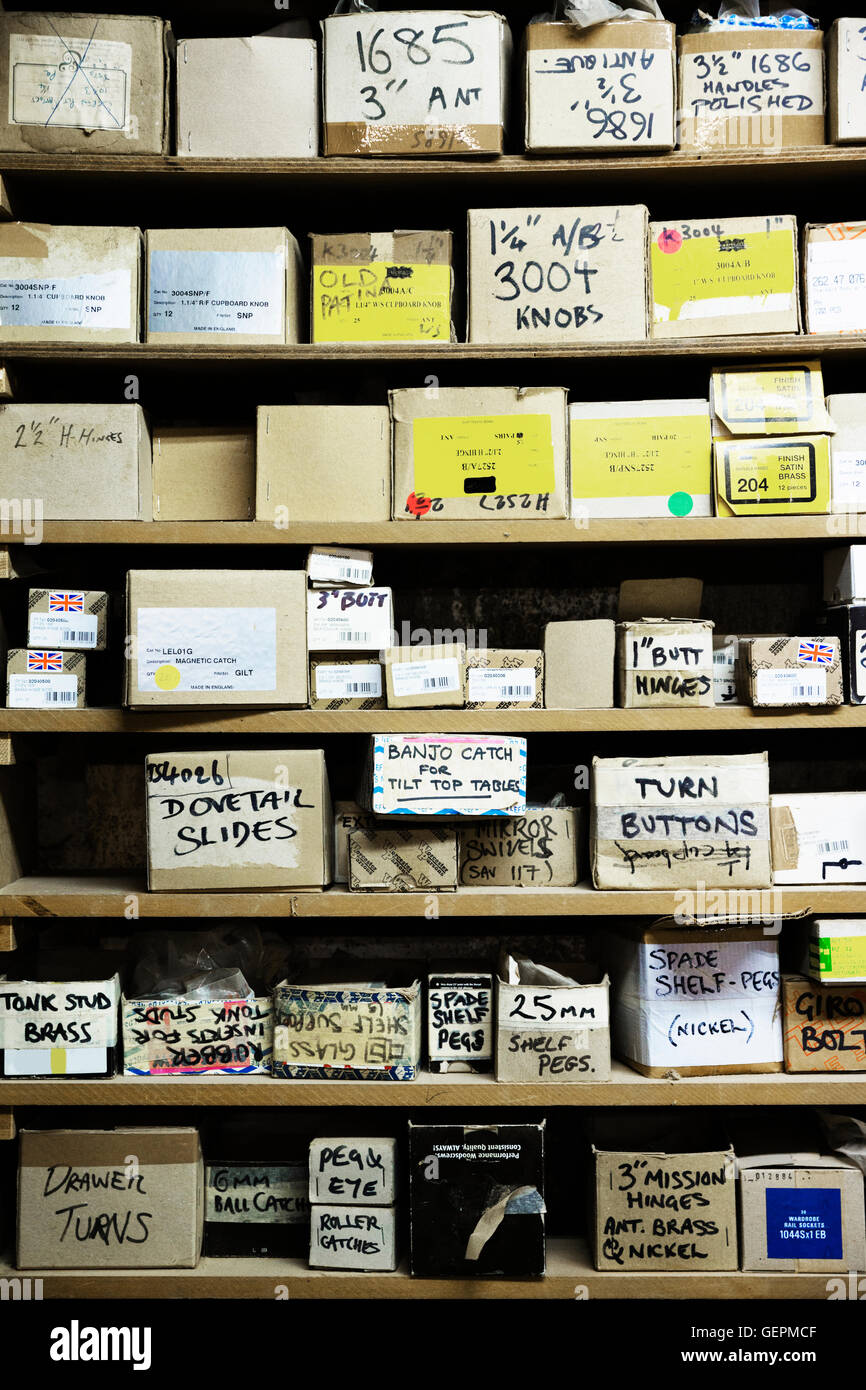 Close up of shelves with cardboard boxes of tool parts in a carpentry ...