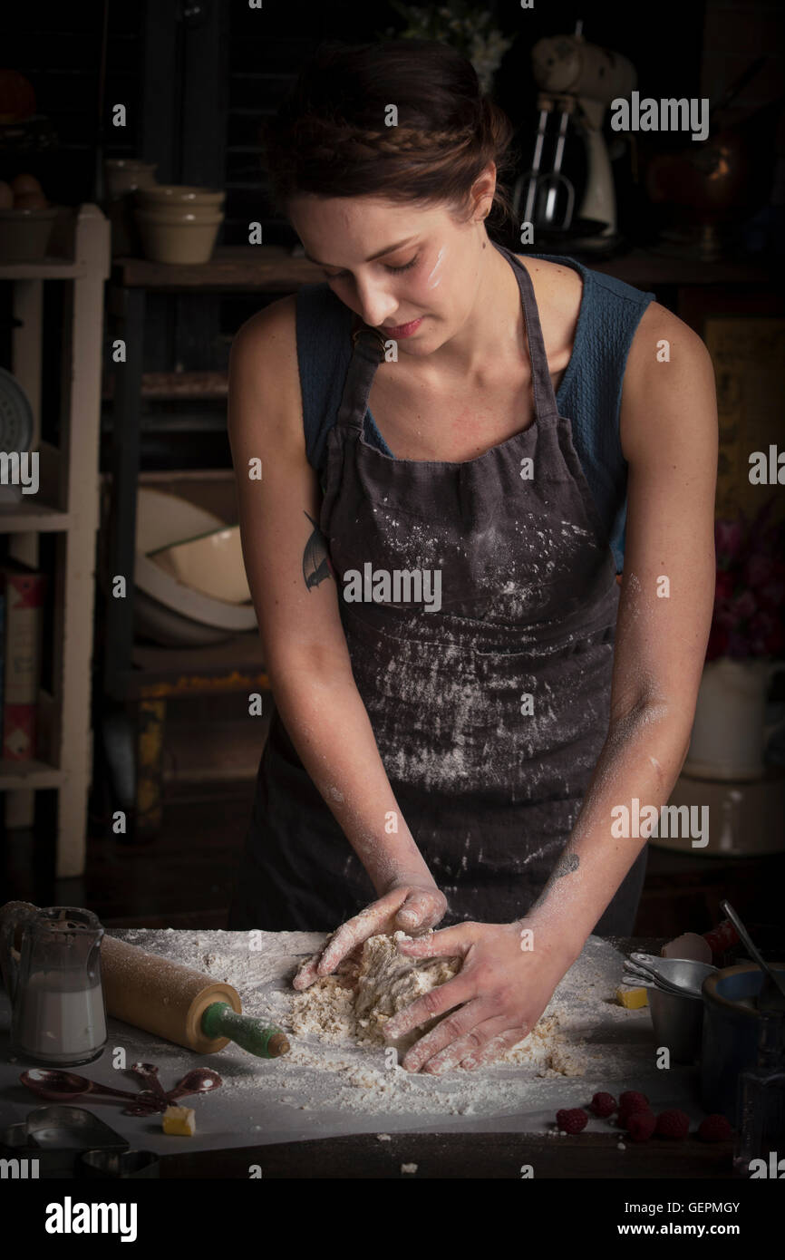 Valentine's Day baking, woman standing in a kitchen, preparing dough ...