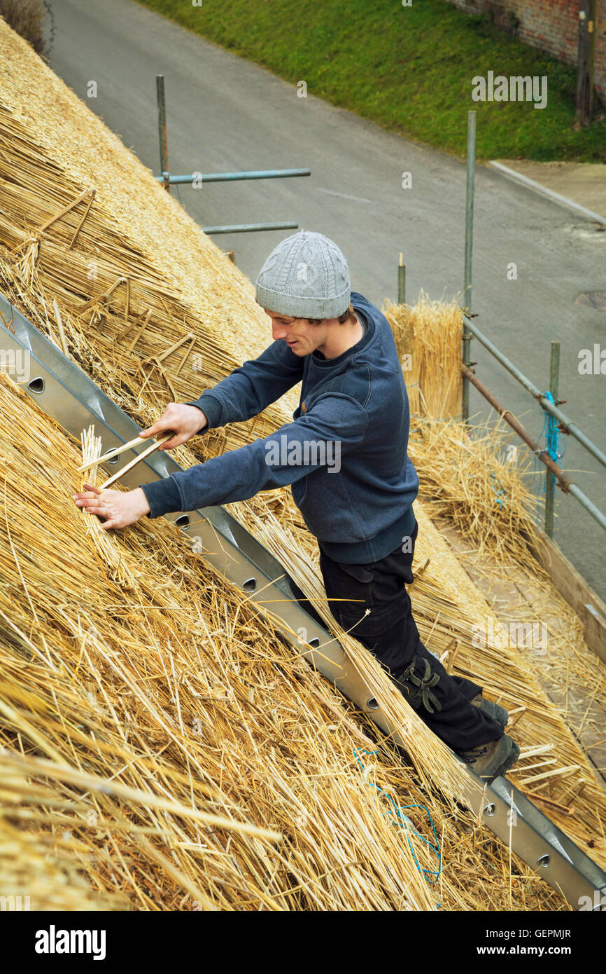 Man thatching roof standing on hi-res stock photography and images - Alamy