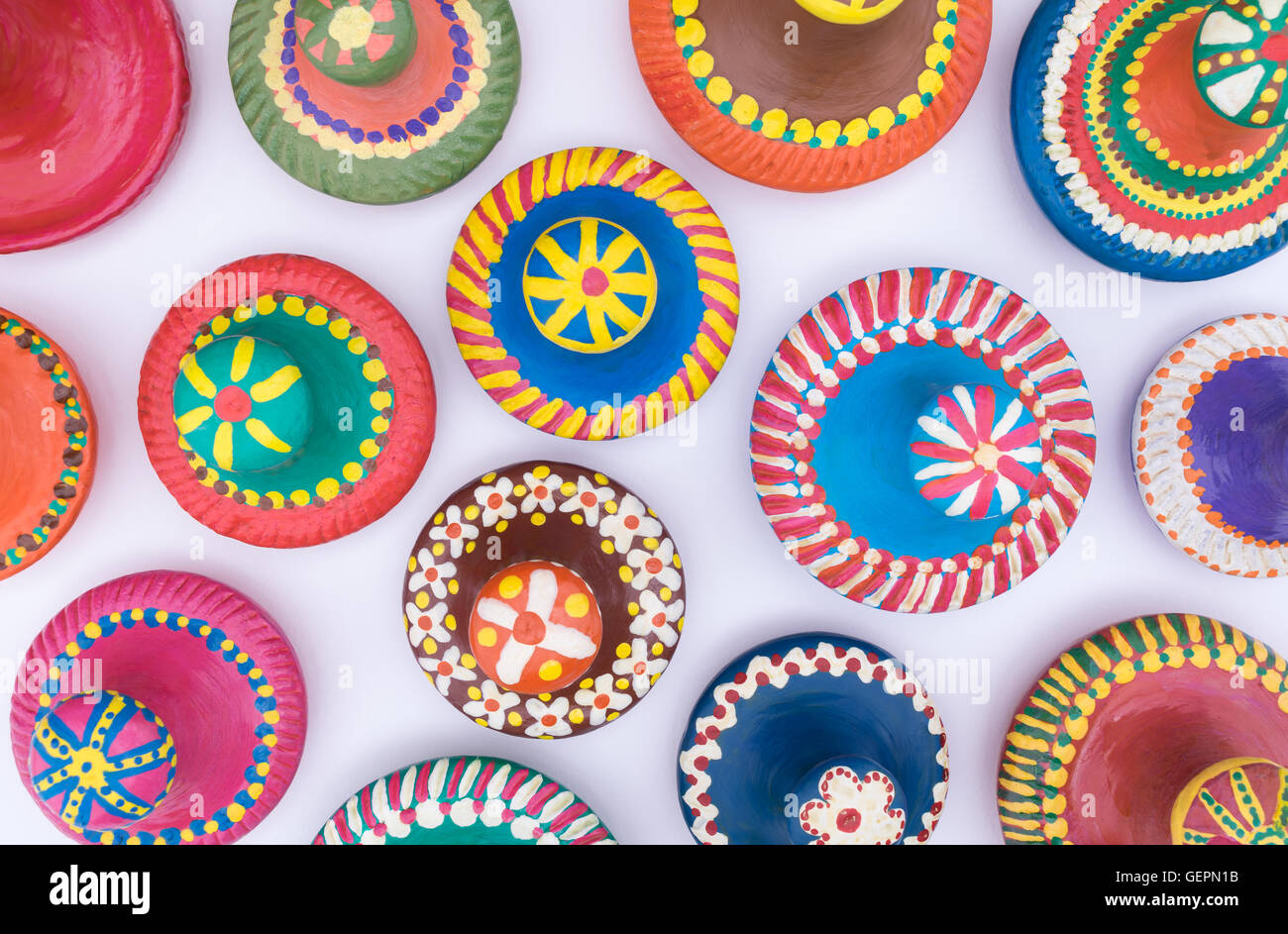 Composition of painted handmade pottery lids on white background Stock ...
