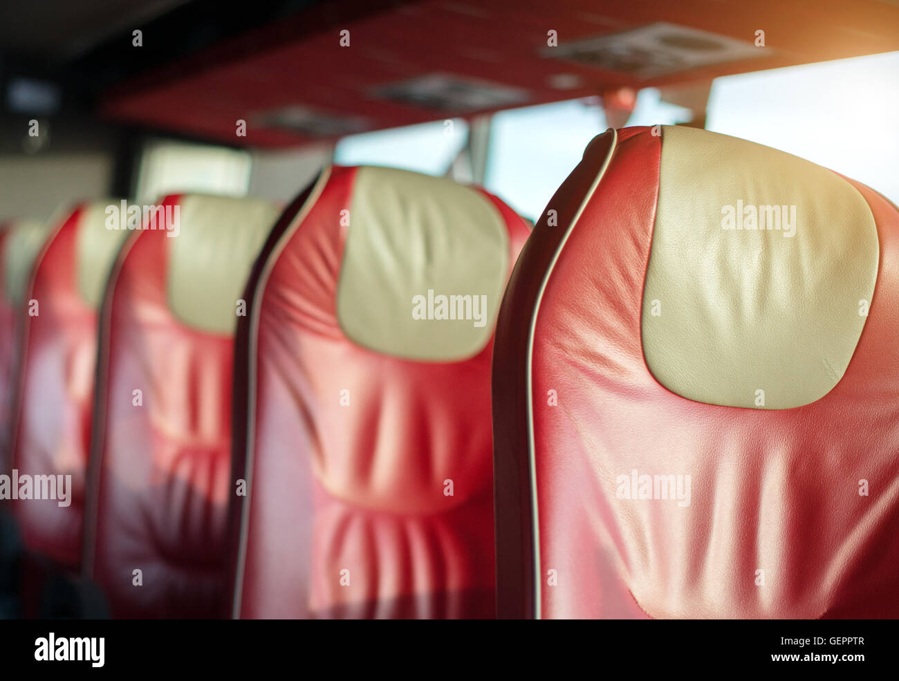 Empty red leather seats in tourist bus Stock Photo - Alamy