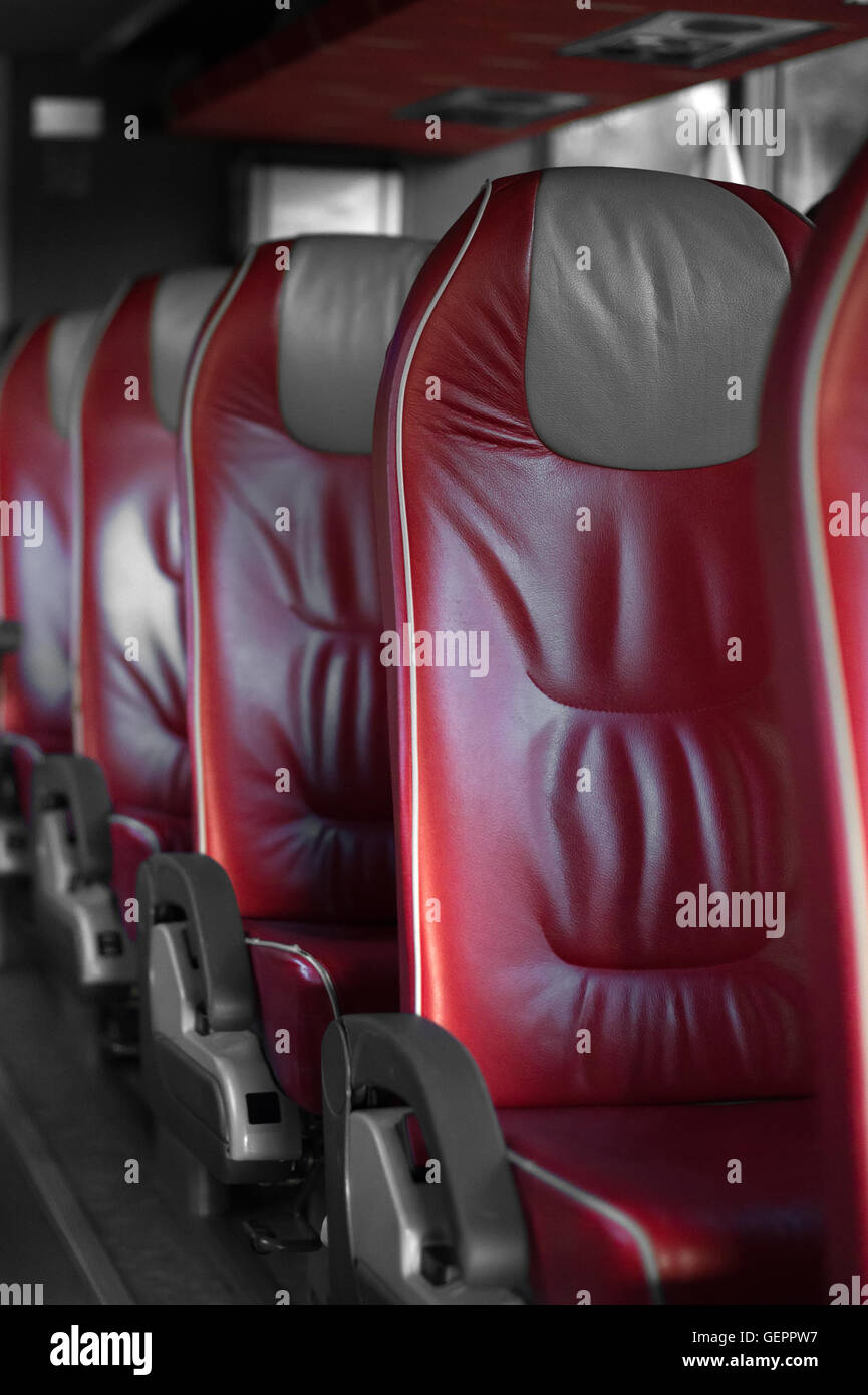 Empty red leather seats in tourist bus Stock Photo - Alamy