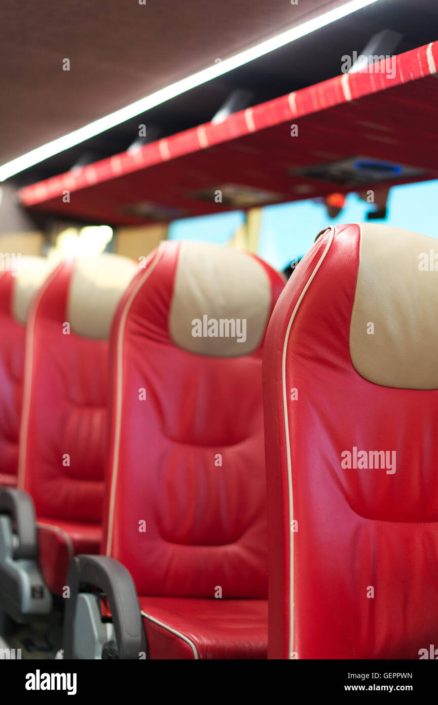 Empty red leather seats in tourist bus Stock Photo - Alamy