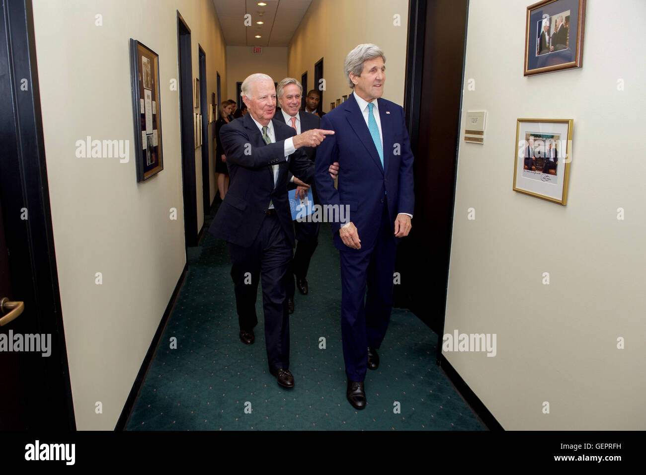 Former Secretary Baker Shows Secretary Kerry Pictures Lining the Hall ...