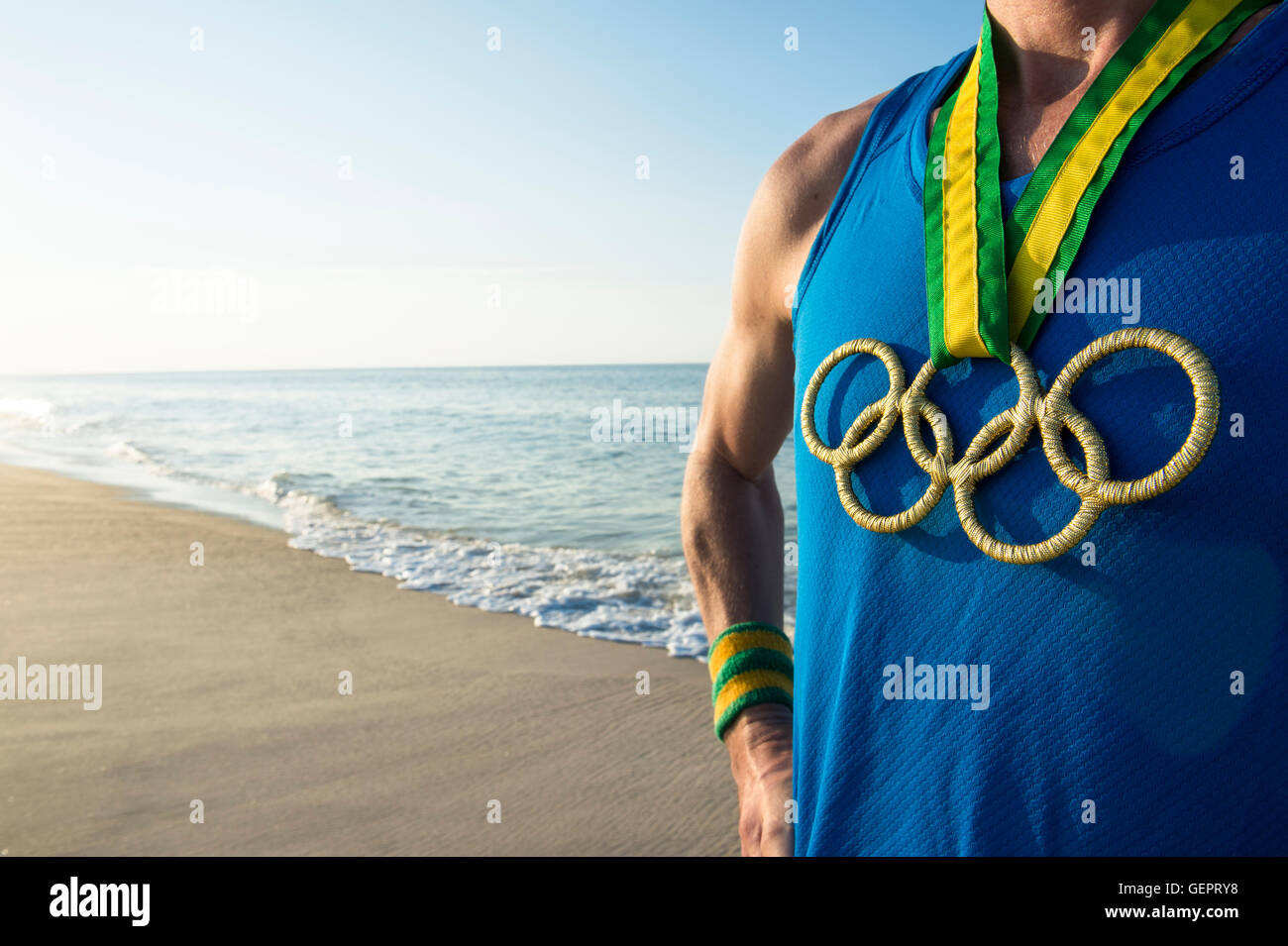 RIO DE JANEIRO - MARCH 10, 2016: Athlete wearing Olympic rings gold ...