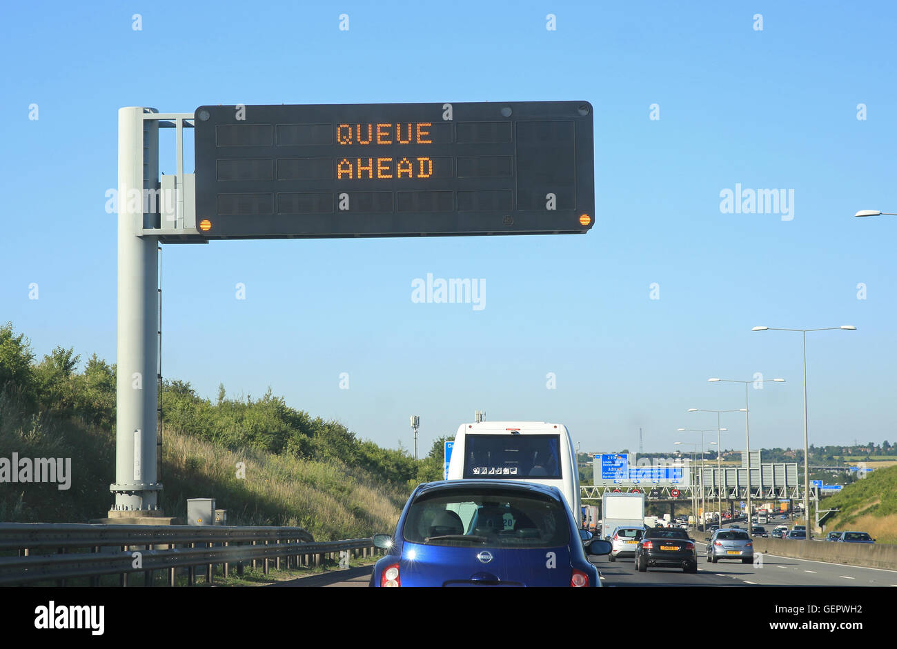 Traffic sign warning of 'queue ahead' on the M25, near London, England ...