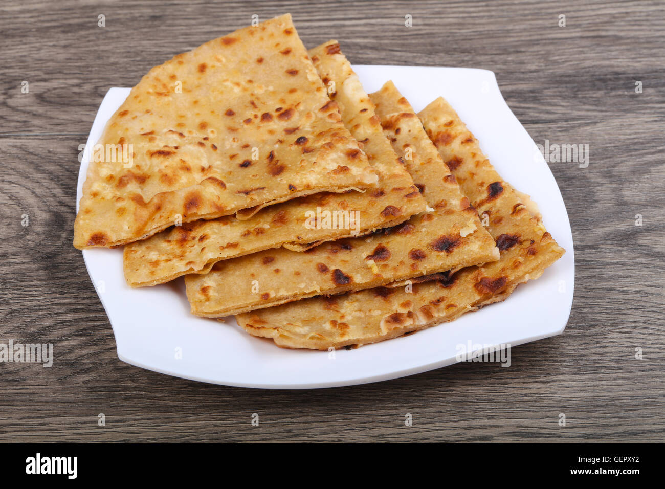 Indian bread roti on the plate in wood background Stock Photo - Alamy