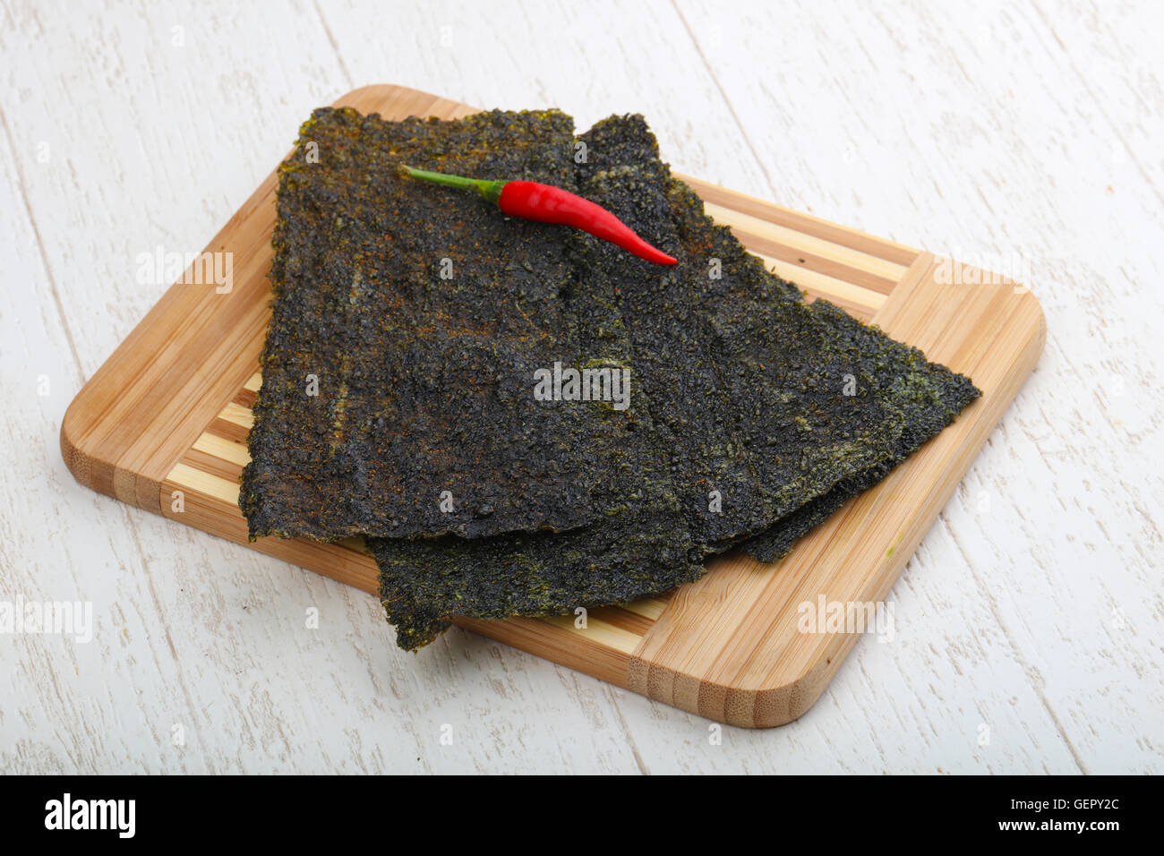 Spicy Nori seaweed sheets with pepper on wood Stock Photo - Alamy