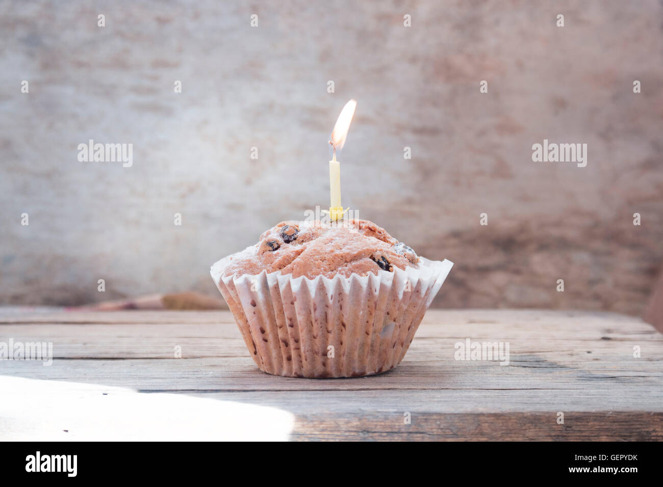 Birthday cupcake with candle Stock Photo - Alamy
