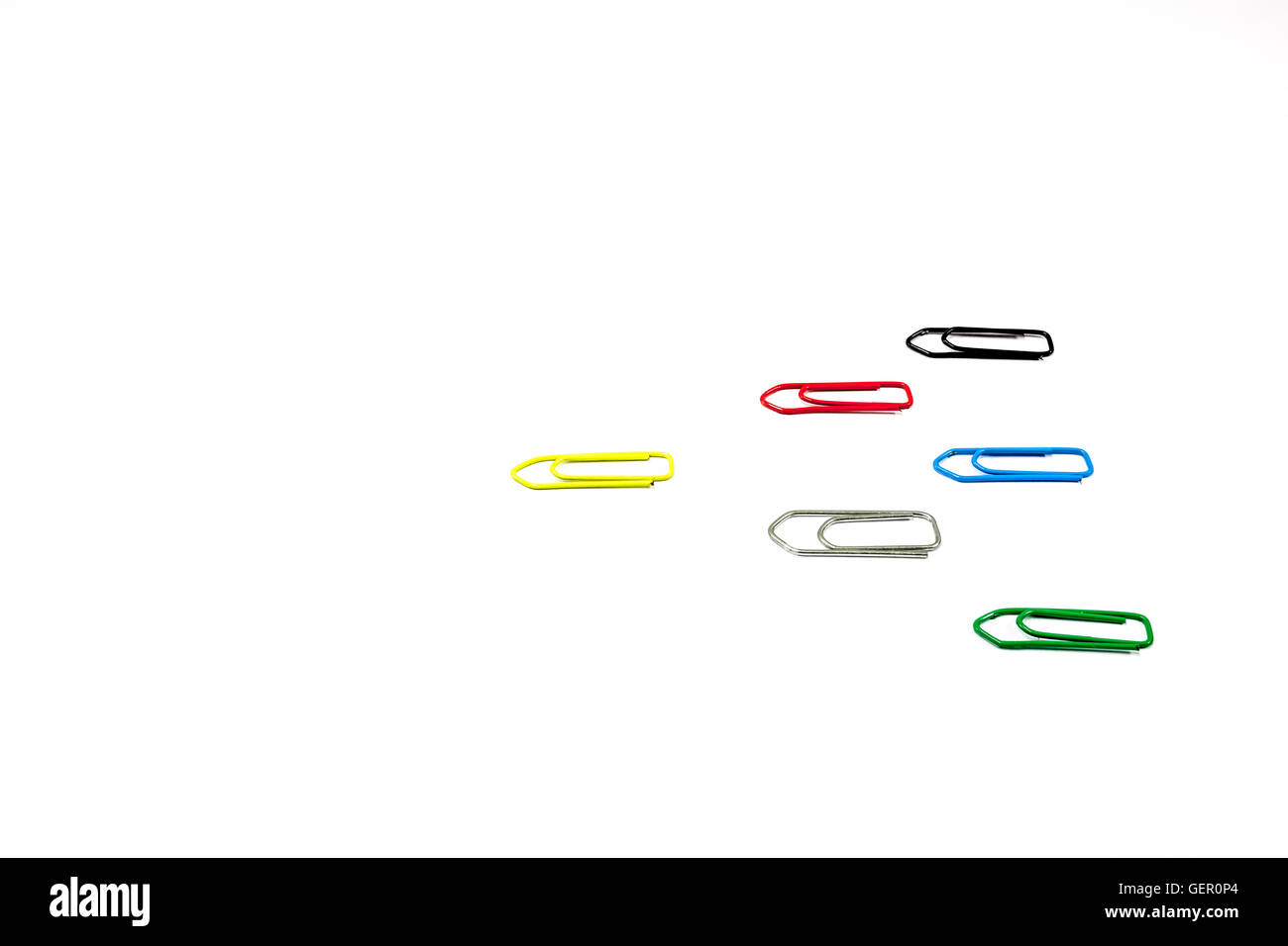 an stack of colored paper clips on a white surface Stock Photo - Alamy
