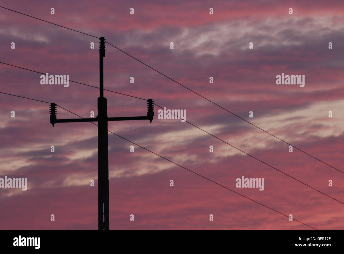 Electric pole on the background of the sunset Stock Photo - Alamy