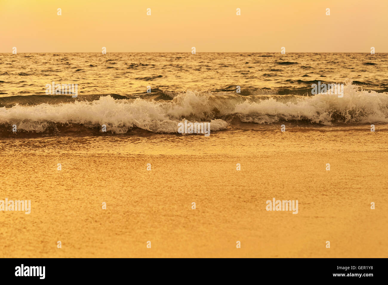 Beach sunrise of the sea with sky in twilight over light the sun and at ...