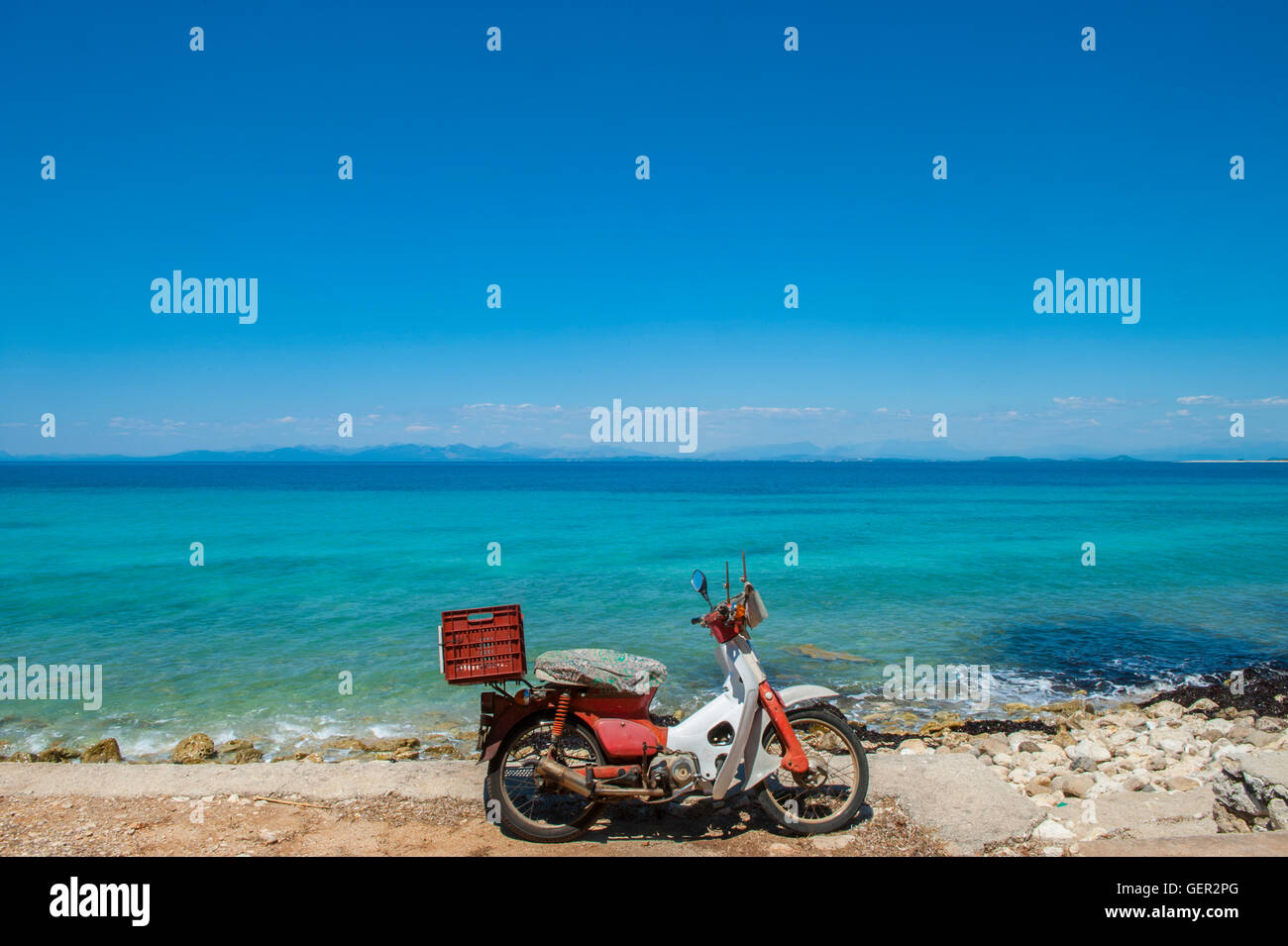 A lone, old moped on a deserted beach in Greece Stock Photo - Alamy