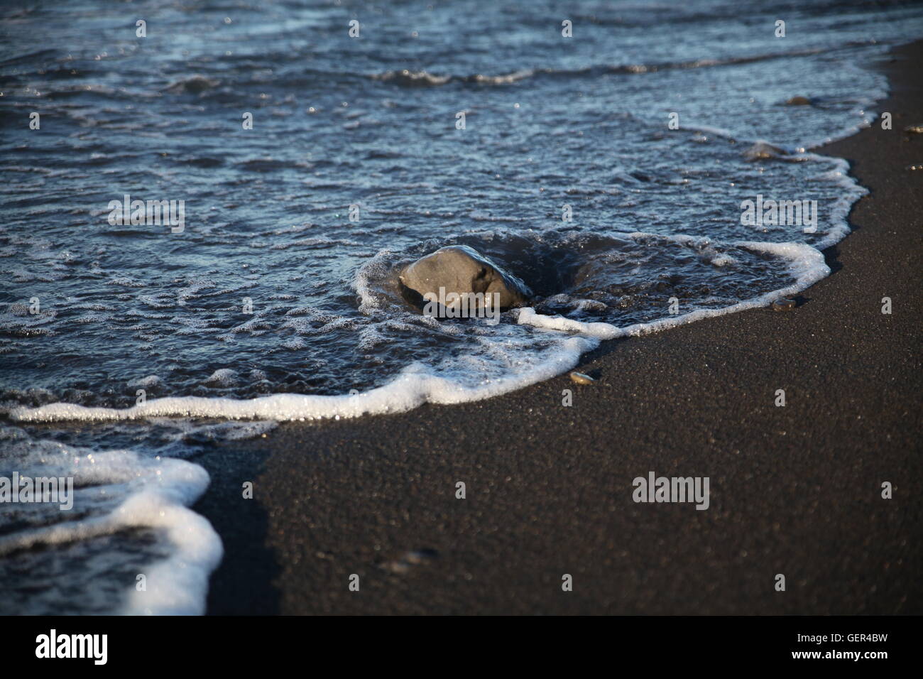 Ocean waves on a stone beach hi-res stock photography and images - Alamy