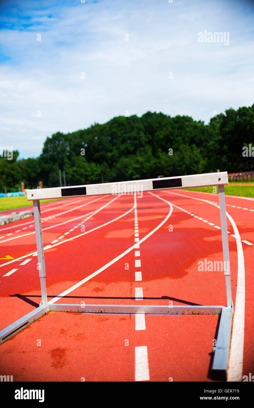 red running athletic track with hurdle, bad weather, wet Stock Photo ...