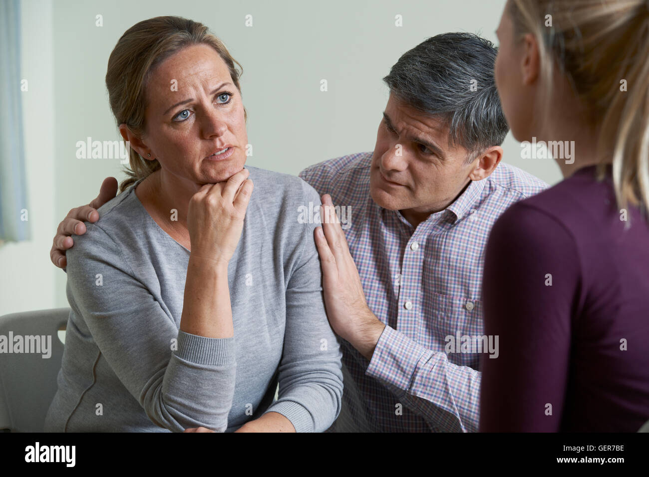 Woman comforts man hi-res stock photography and images - Alamy