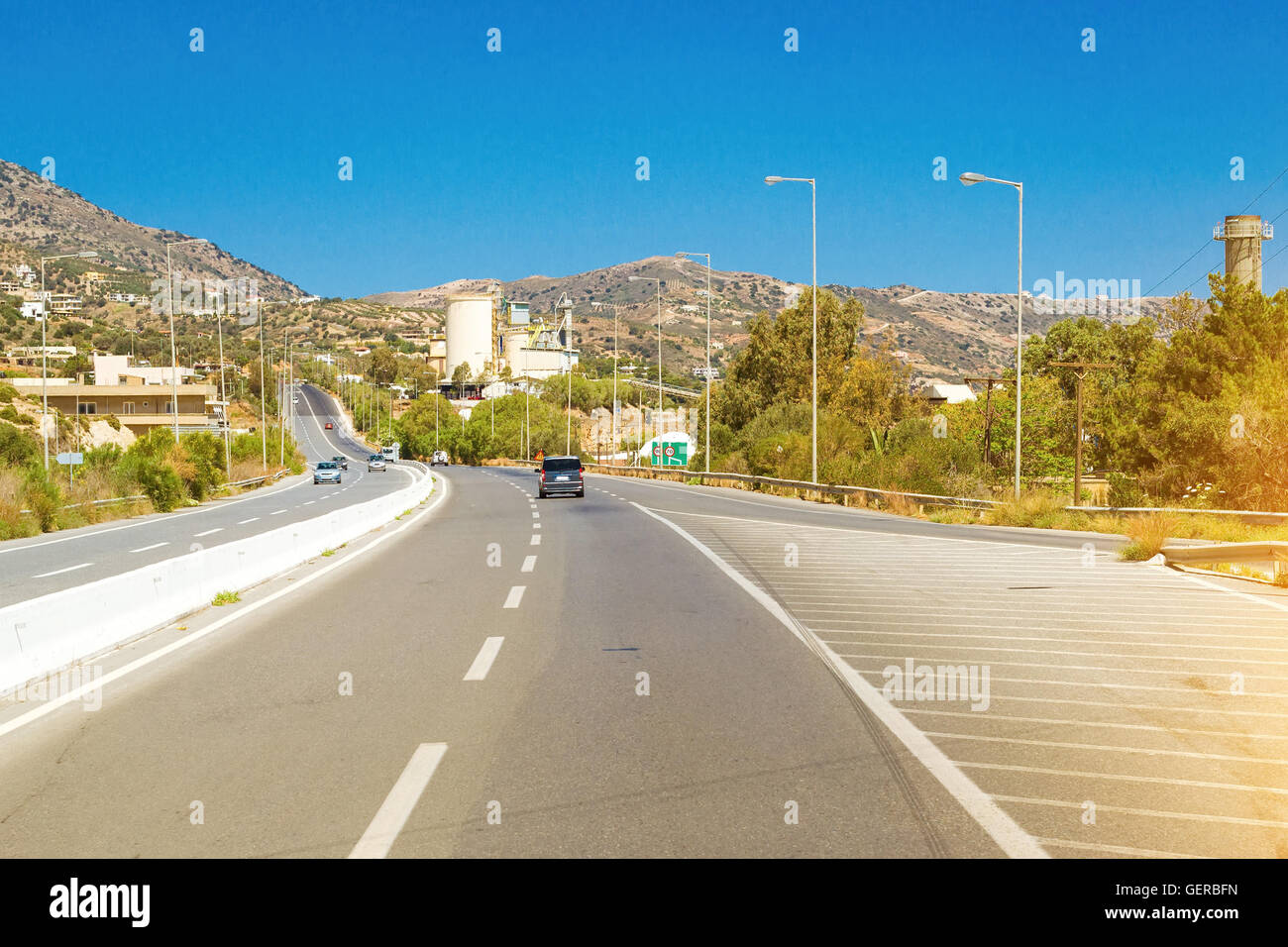 Mountain roads and serpentines of Crete, cars move along the winding ...