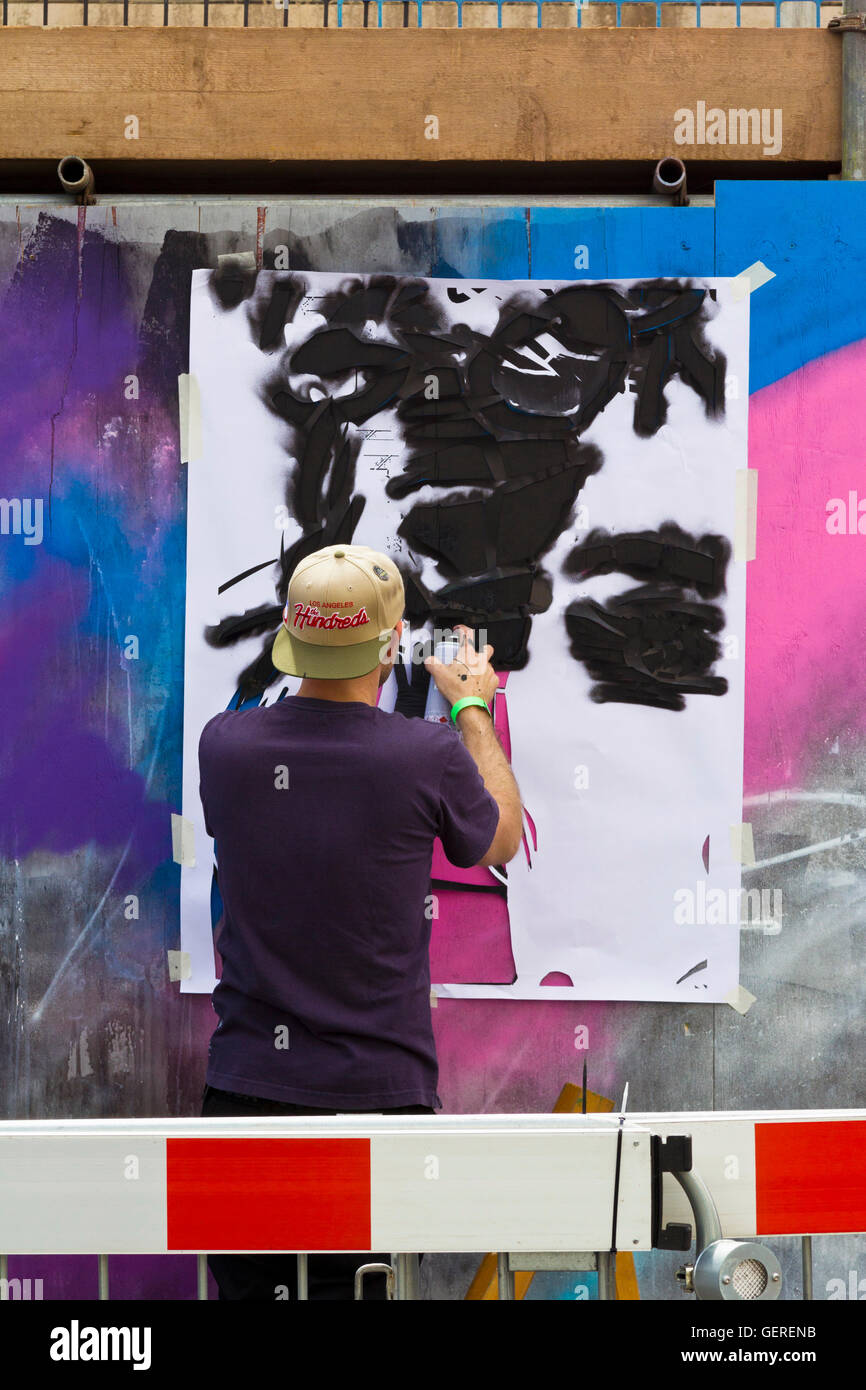 Street artist painting at Upfest (street art festival) in Bedminster ...