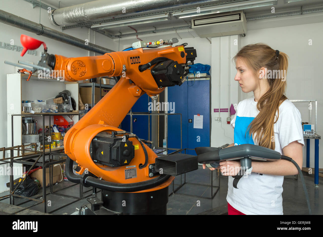 Poznan, Poland, student demonstrates the work with an industrial robot ...