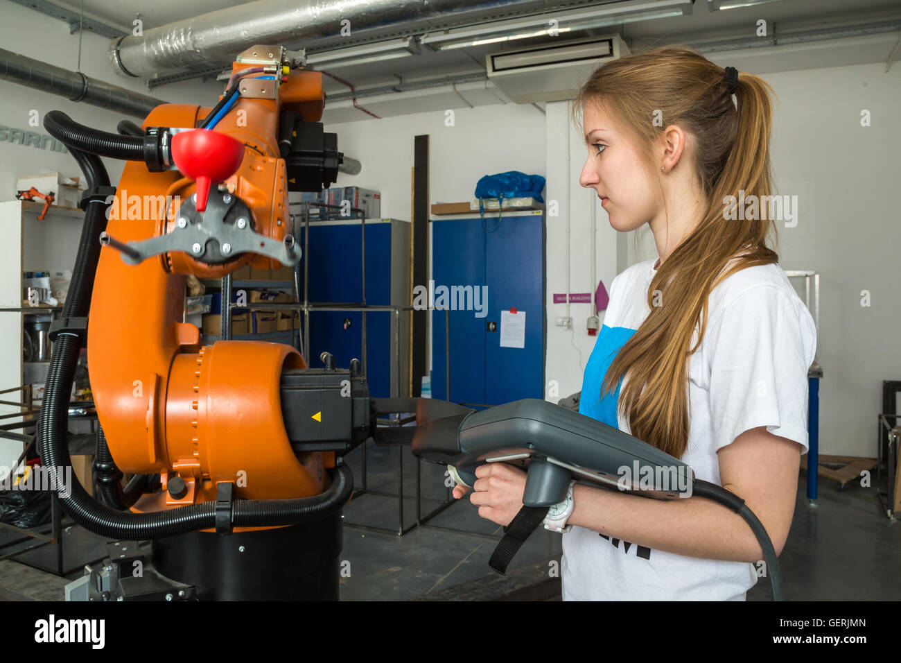 Poznan, Poland, student demonstrates the work with an industrial robot ...