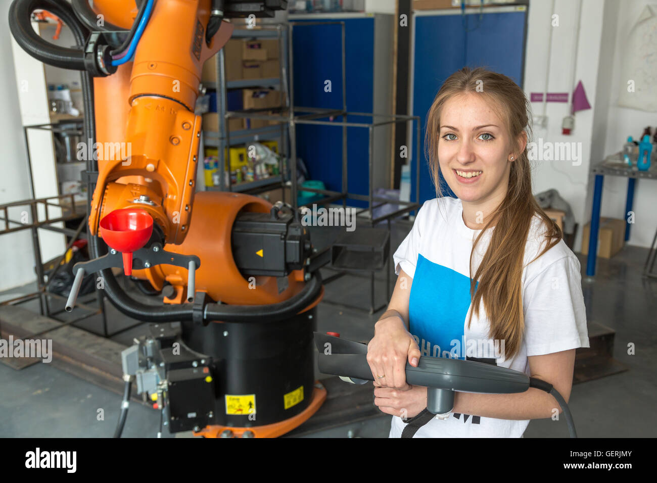 Poznan, Poland, student demonstrates the work with an industrial robot ...
