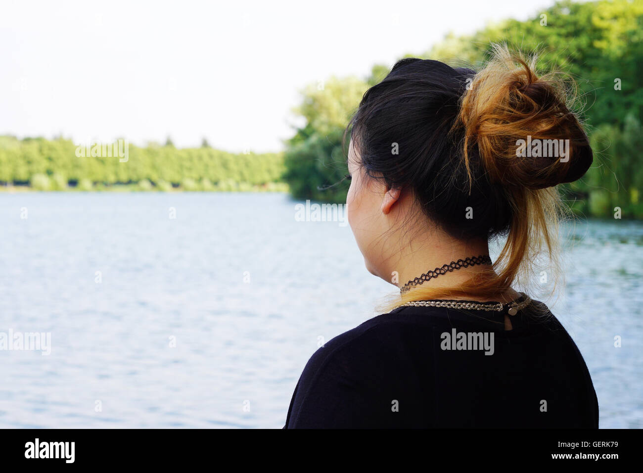 young woman looking over lake Stock Photo - Alamy