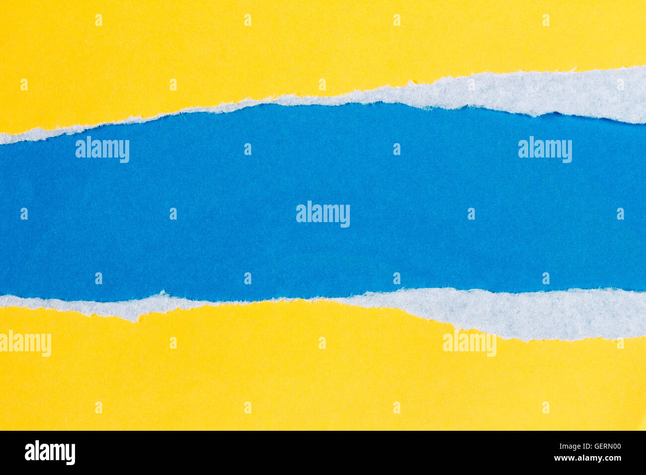 Torn yellow paper with a blue background for your text Stock Photo - Alamy