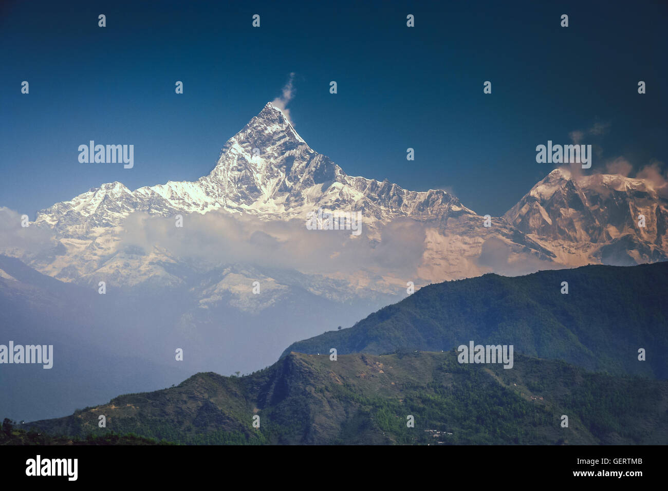 Mount Machhapuchhre dominating above city of Pokhara, Nepal Stock Photo ...