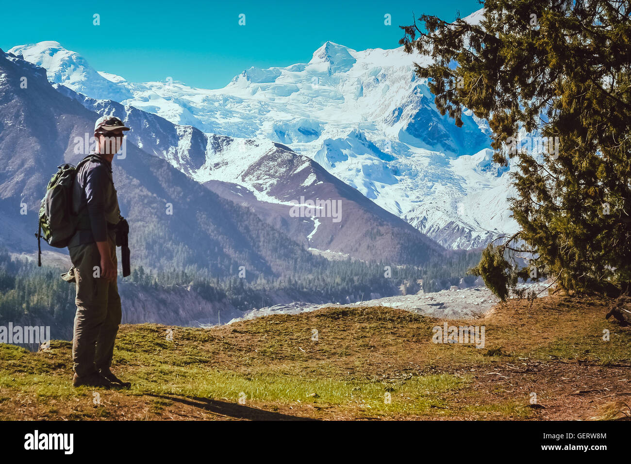 Trekker walking up the stony mountain trail in Karakorum in Pakistan ...