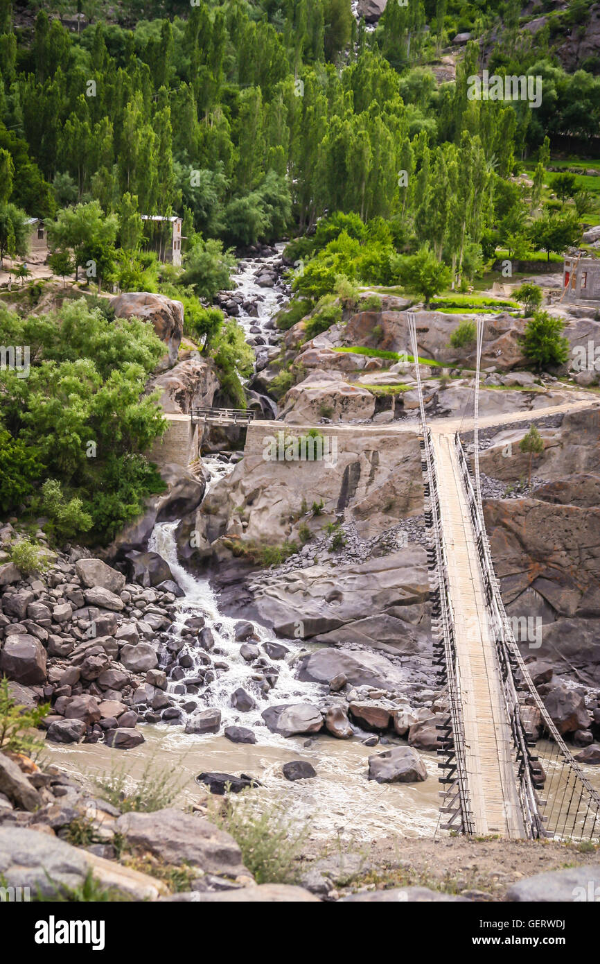 Dangerous crossing the long hanging bridge over mountain river in ...