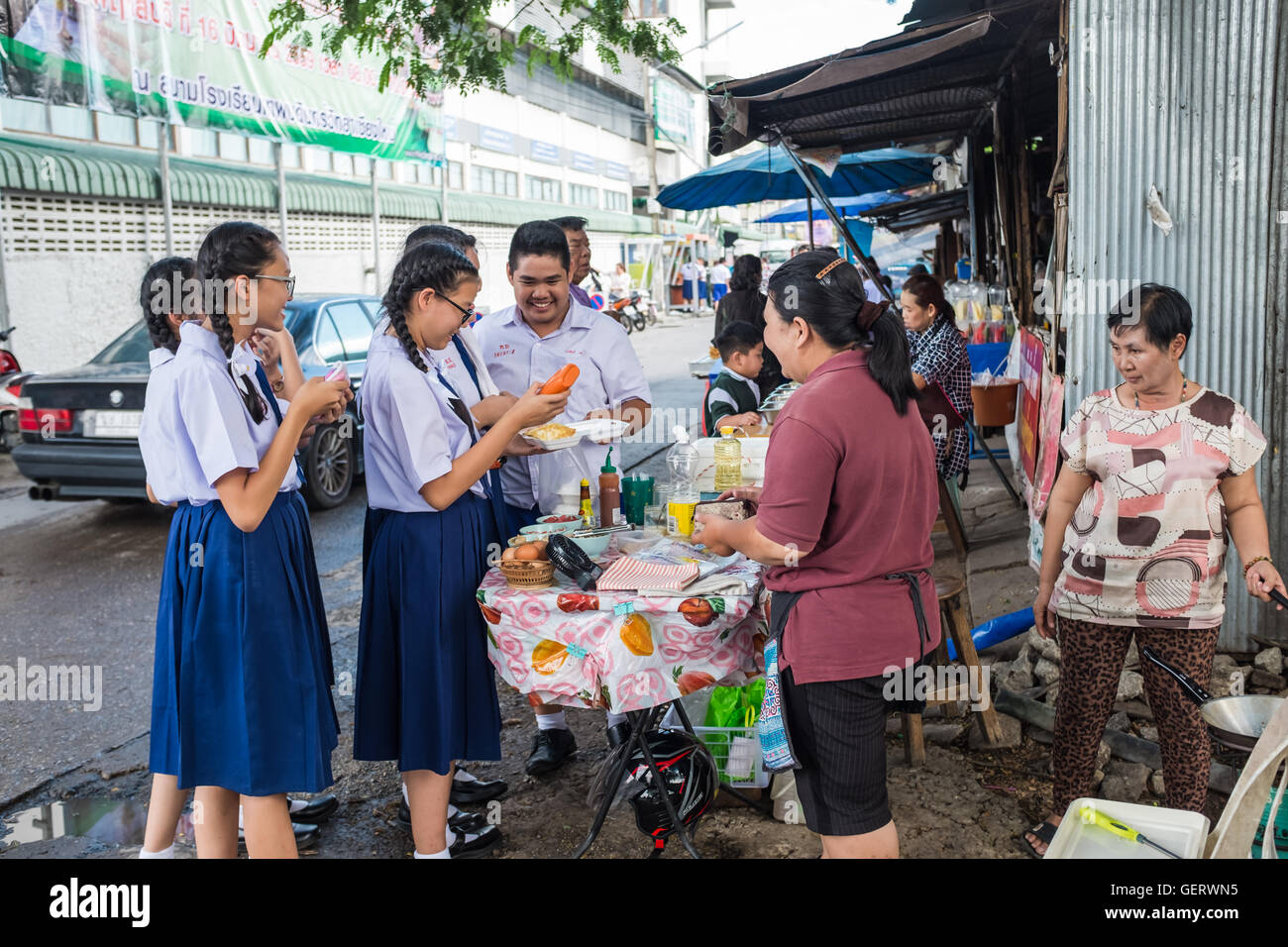 School children buying snack food from street food trader,Chiang Mai ...