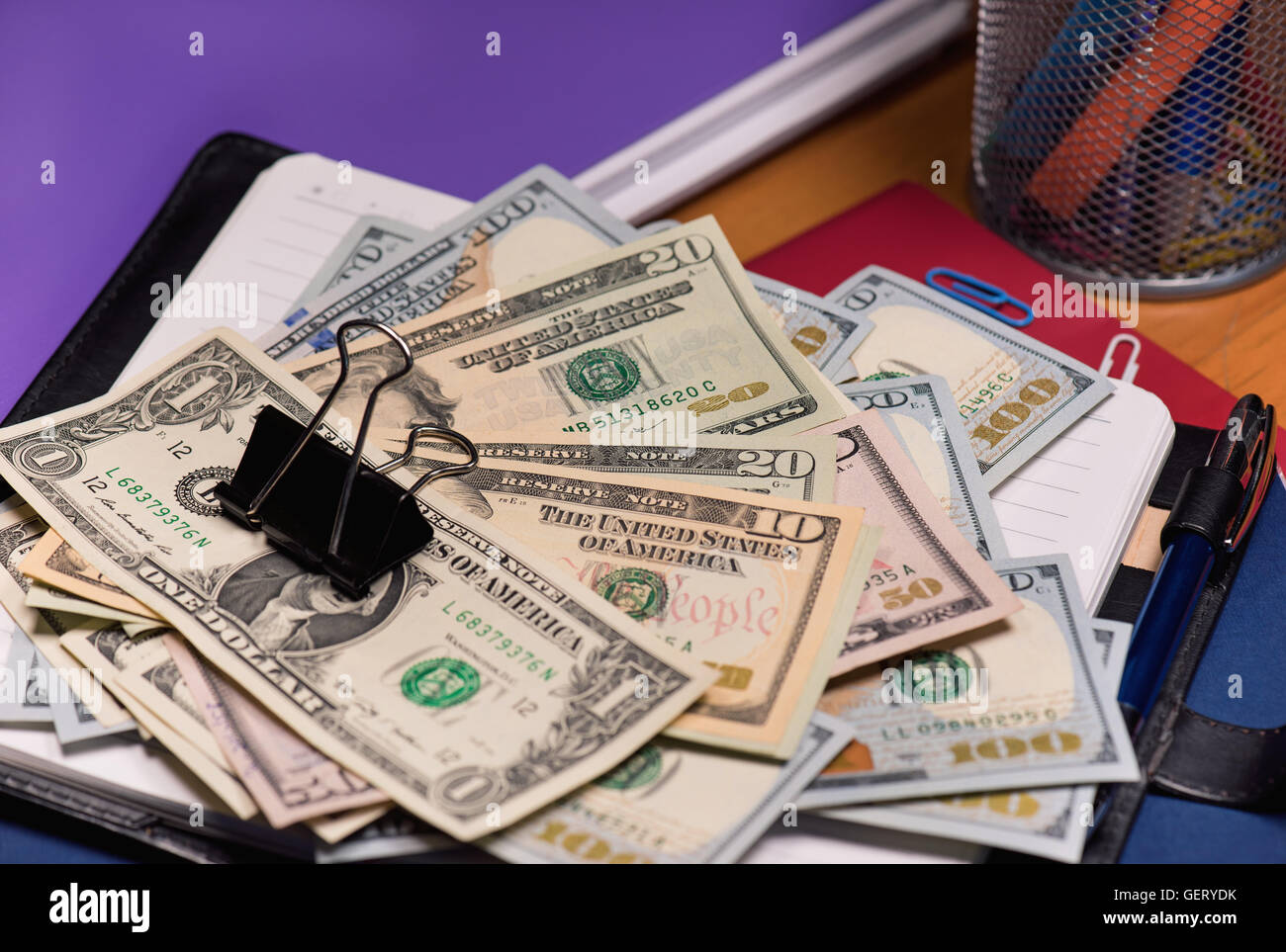 Notepad with dollar banknotes Stock Photo - Alamy