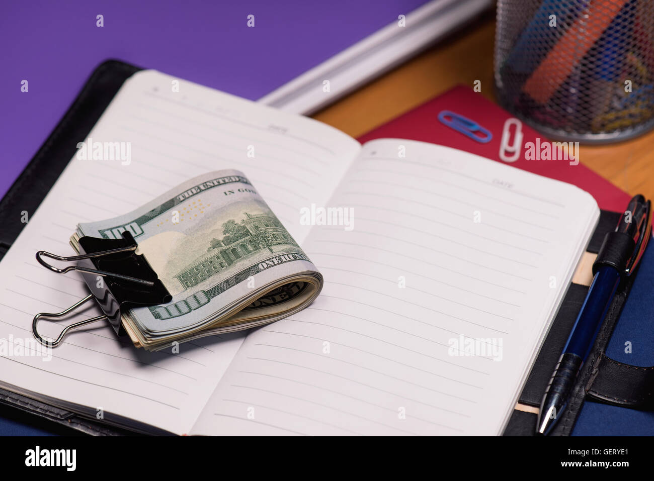 Notepad with dollar banknotes Stock Photo - Alamy