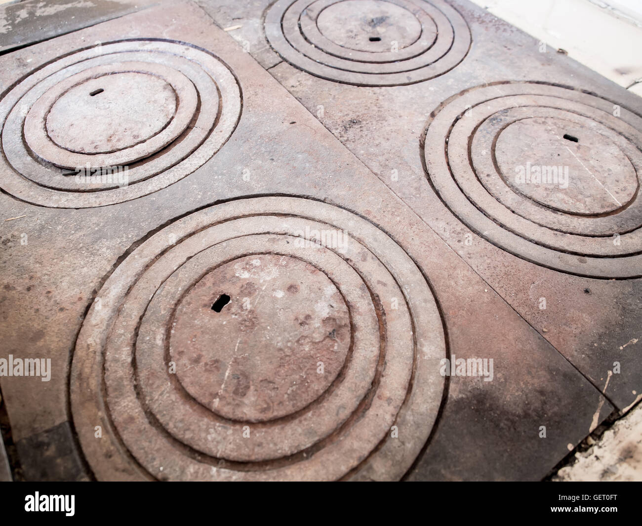 An iron stove lids of a coal tile oven Stock Photo - Alamy