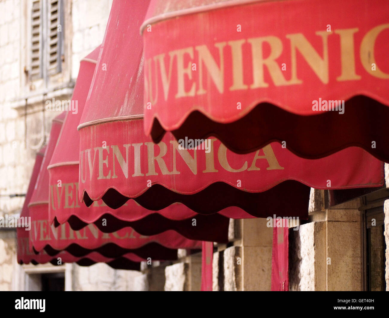 receding red canopies advertising in gold lettering a souvenir shop in ...