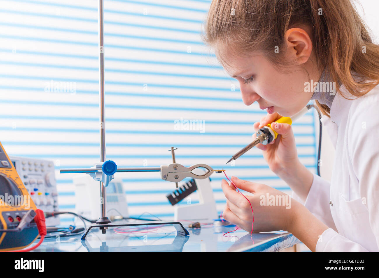 Girl solder wires Stock Photo - Alamy