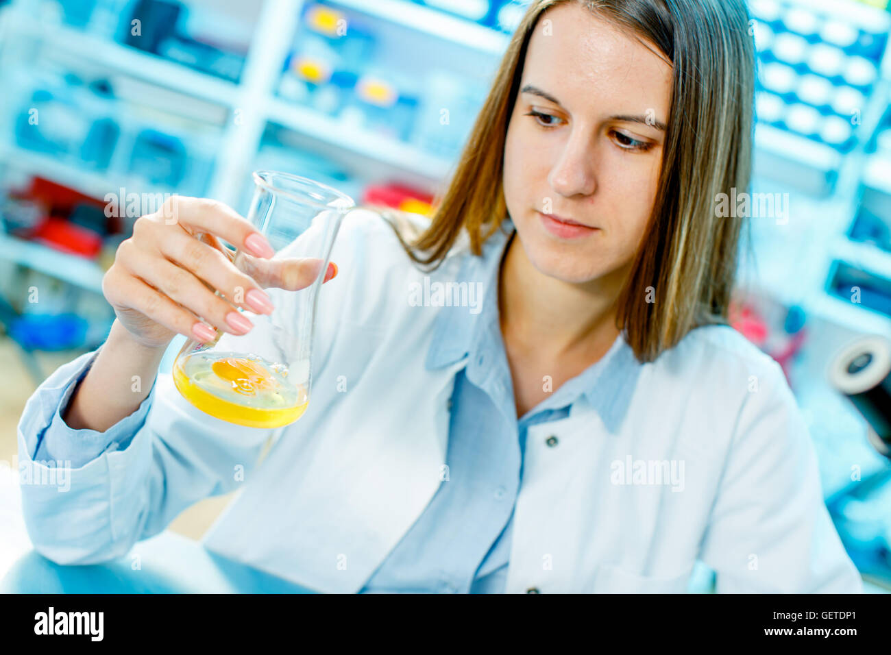 girl in the laboratory testing of food quality egg. Check the content ...